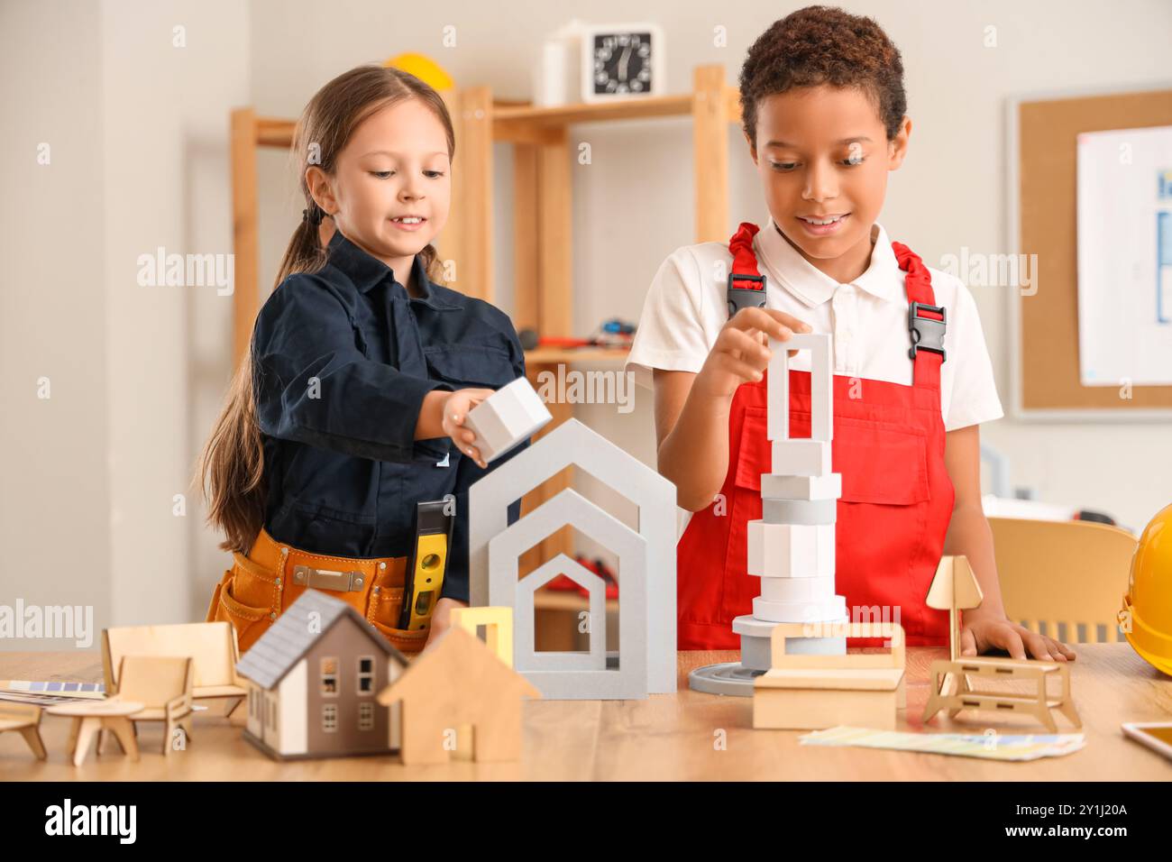 Cute little architects building houses with figures at home Stock Photo ...