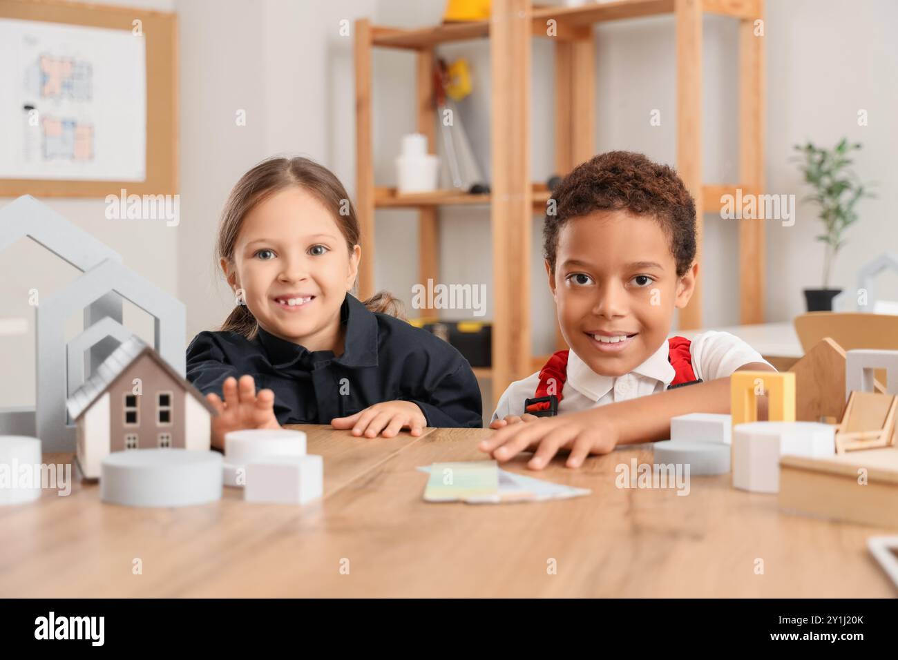 Cute little architects building houses with figures at home Stock Photo ...