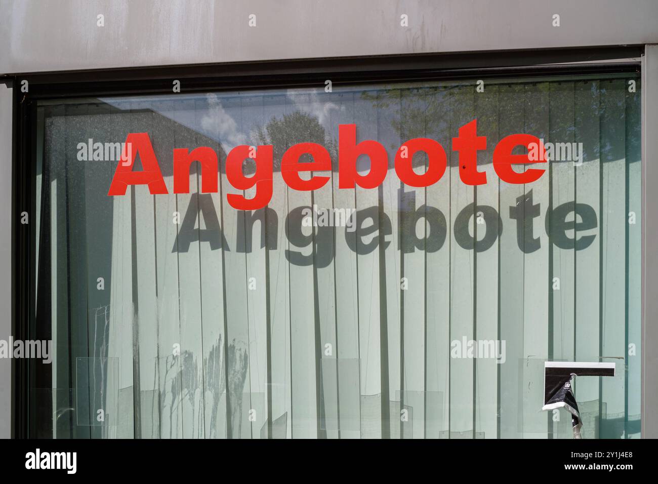Dilapidated storefront window displays the word "Angebote" ("Offers" in ...