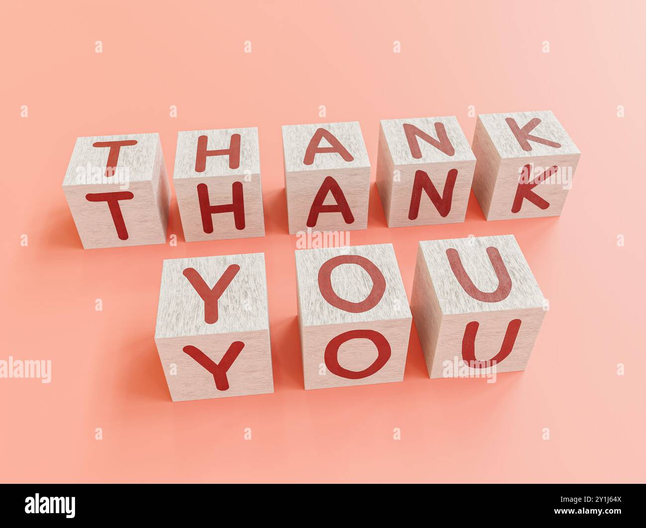 White painted wooden cubes with red letters arranged into Thank You ...