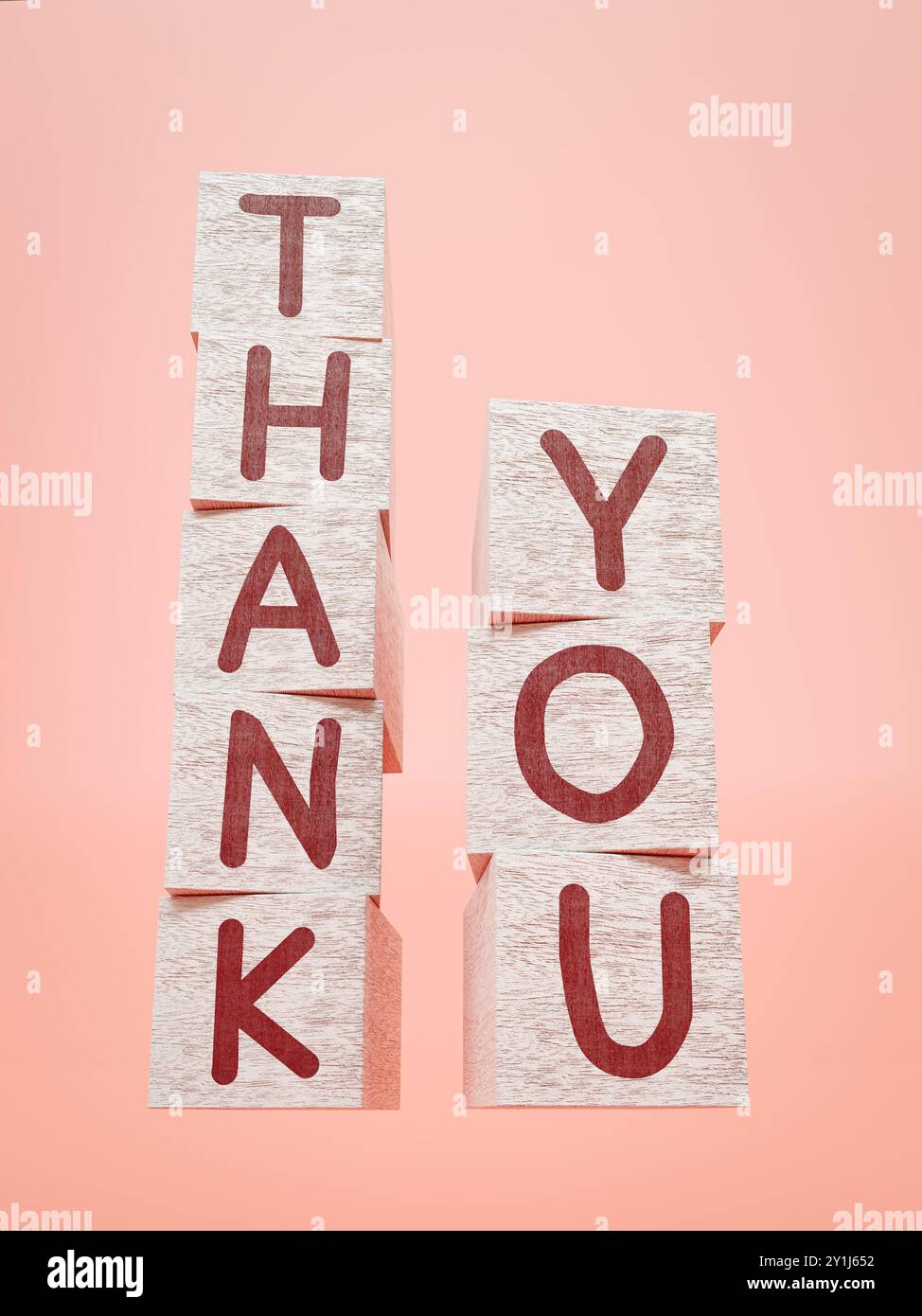 White painted wooden cubes with red letters arranged into Thank You ...
