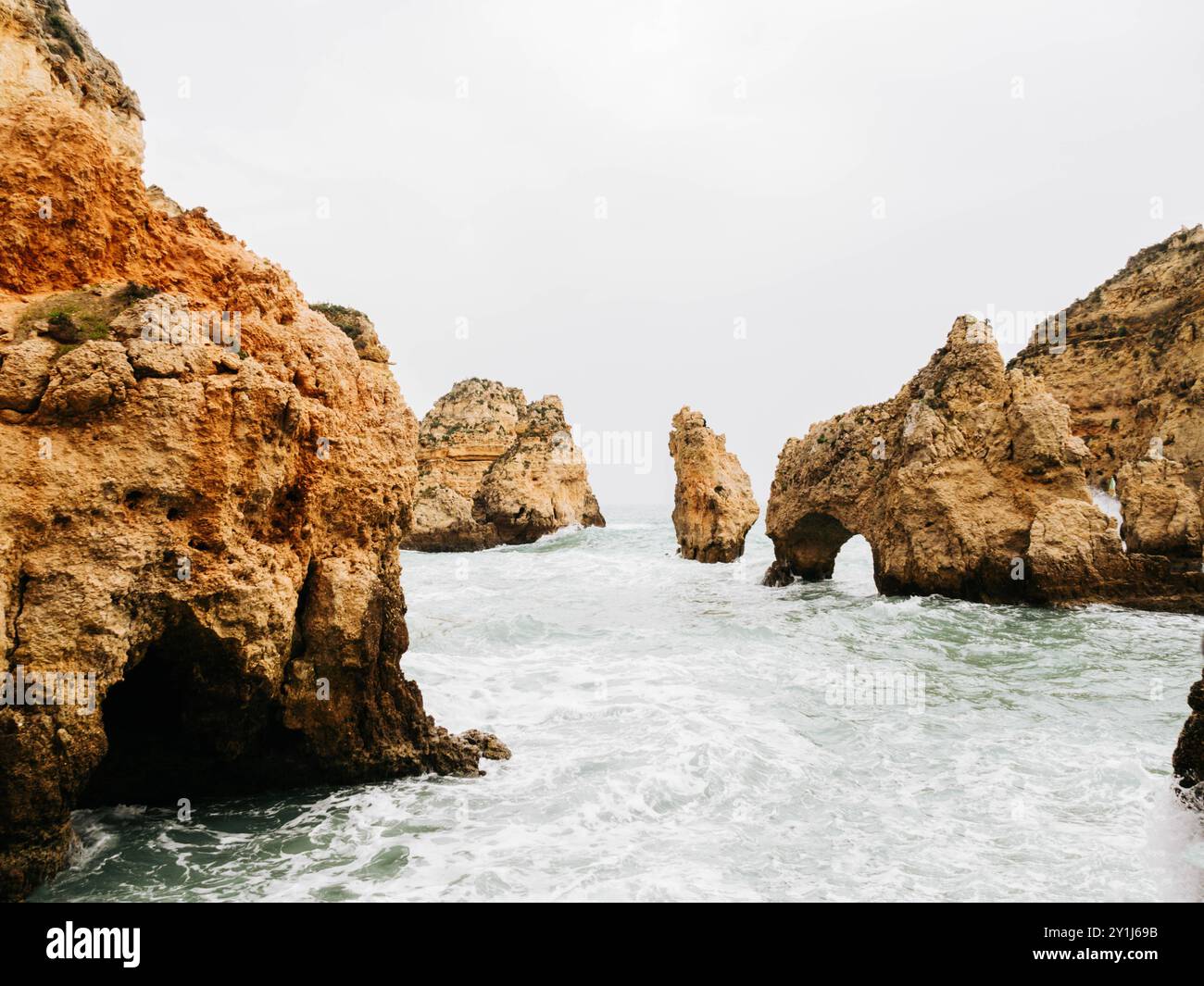 Rugged coastal rock formations rising from the ocean, with natural ...
