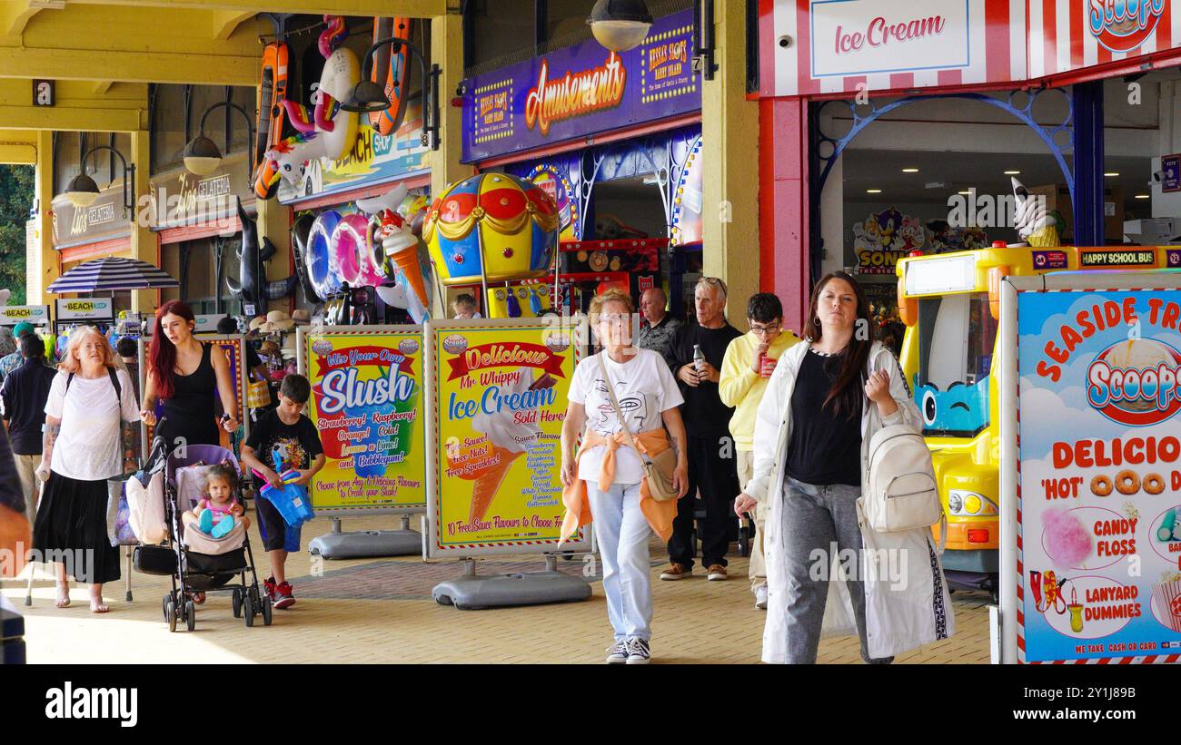 Barry Island, Wales, Aug 30 2024: People walk in the shelters at Barry ...