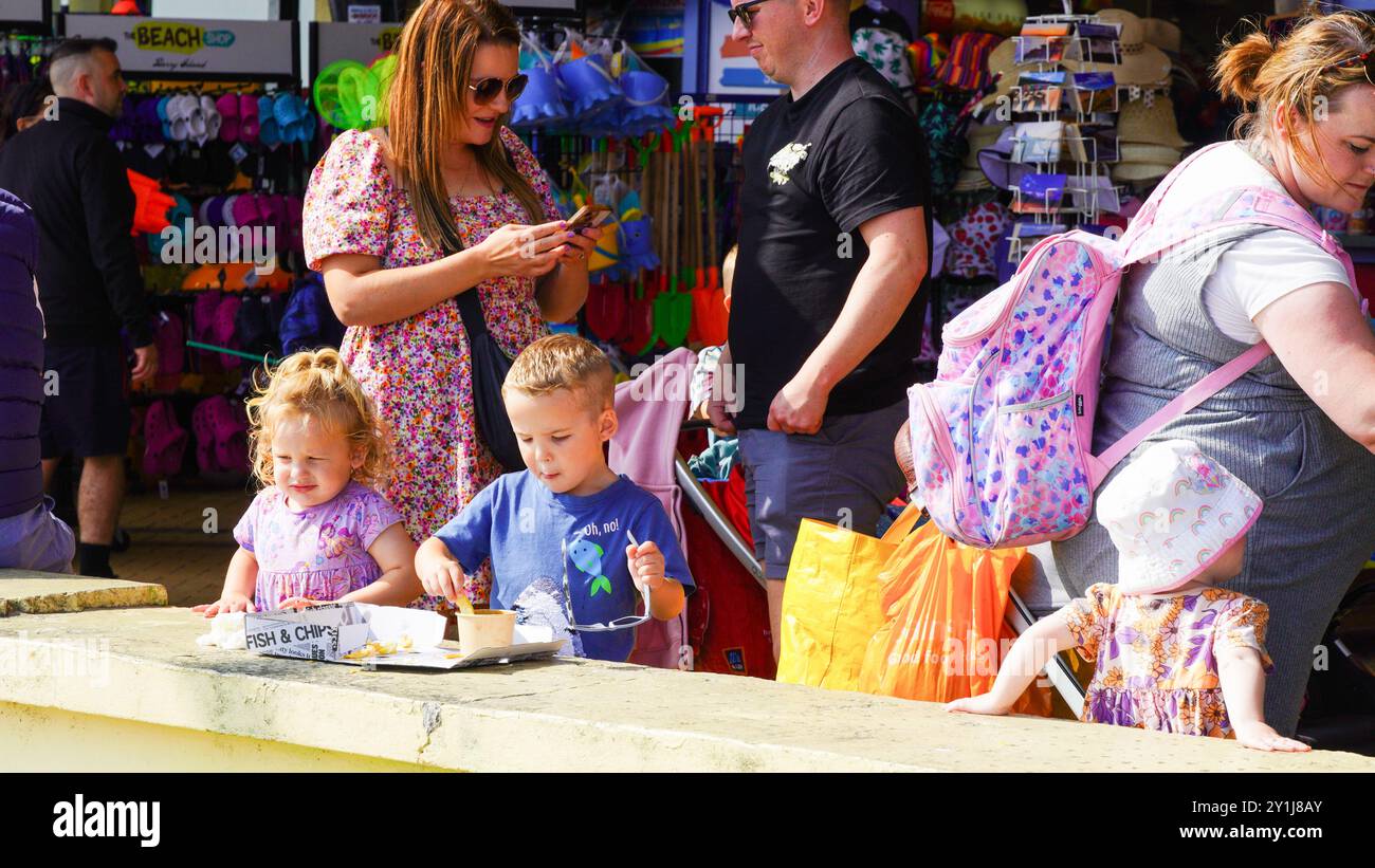 Barry Island, Wales, Aug 30 2024: People walk in the shelters at Barry ...