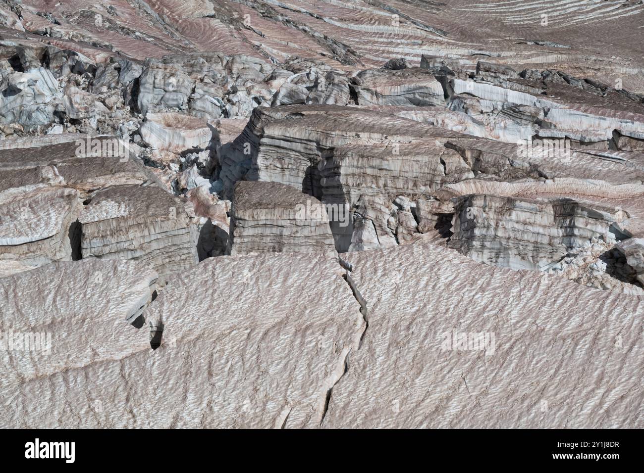 Mer de Glace glacier in close-up showing layer of red Sahara sand dust ...