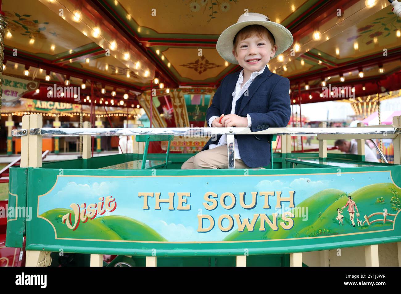 A young race meet goer on the vintage funfair at the Goodwood Revival ...