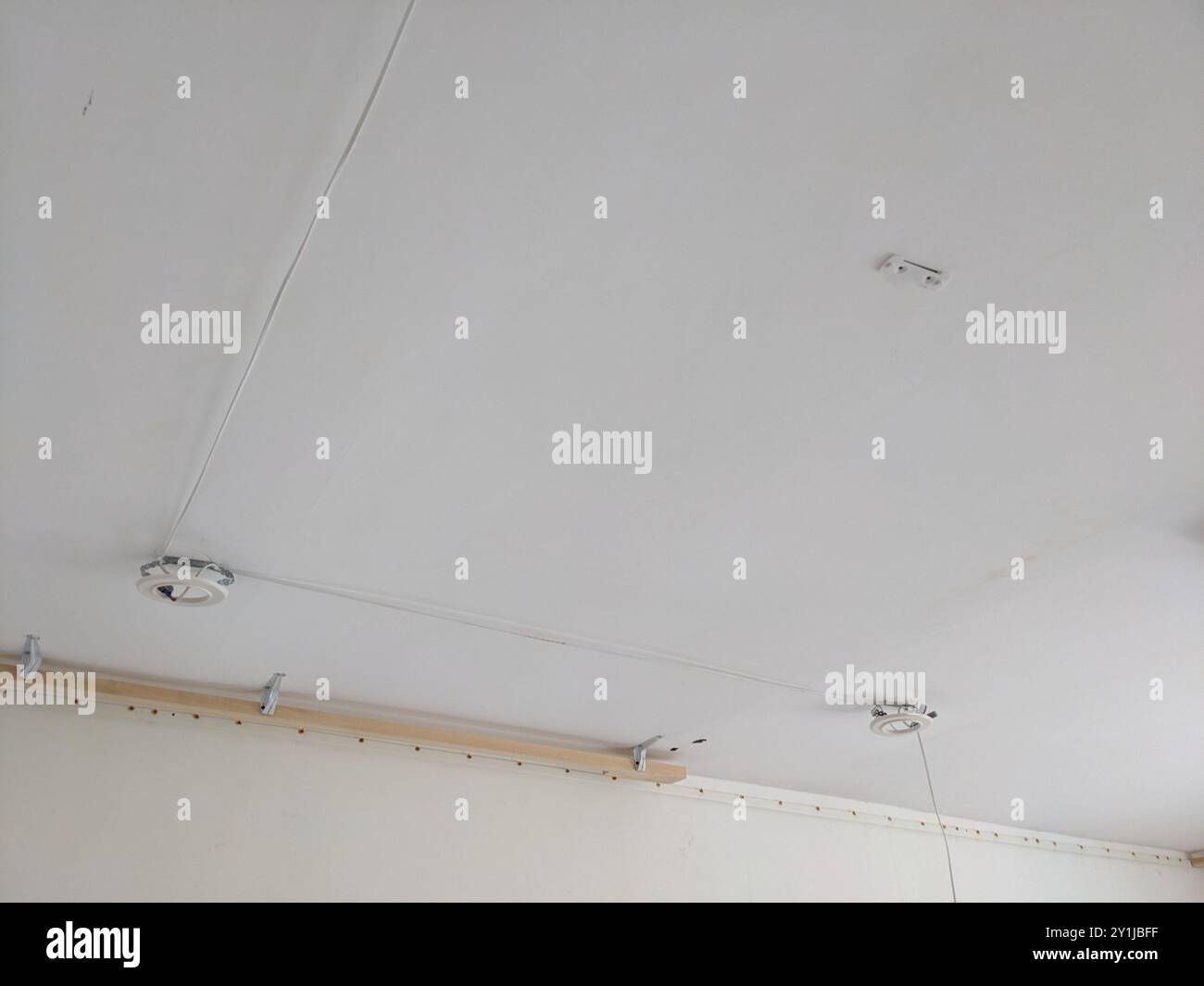 Installing a stretch ceiling on a laser level Stock Photo - Alamy