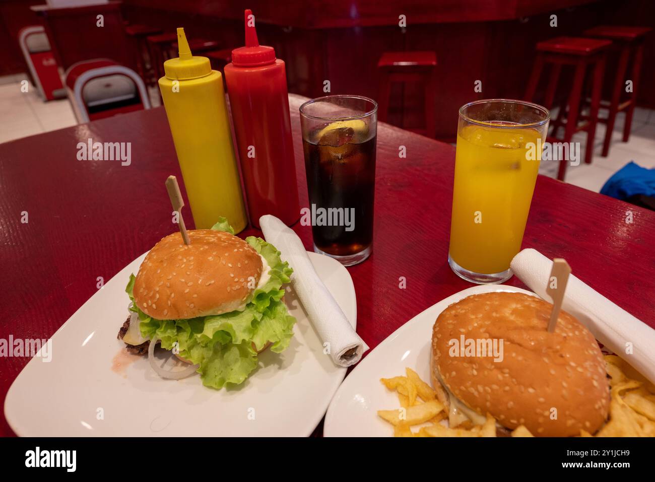 Meal for two in a fast food: two tasty grilled burgers with french ...