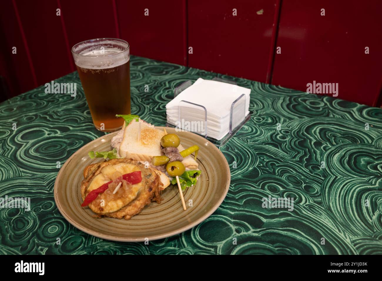 Delicious spanish pintxos with ham, olives, green pepper, omelette ...