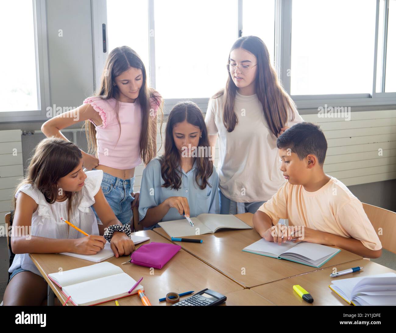Group of elementary school students working as a team on a project in ...