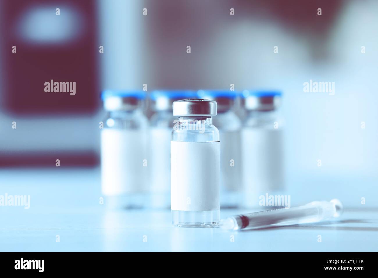 Medication in vials with blank labels and syringe on white table Stock ...