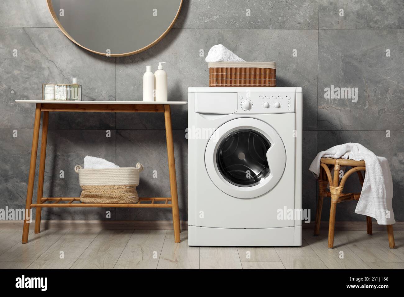 Washing machine, storage bench and chair indoors Stock Photo - Alamy