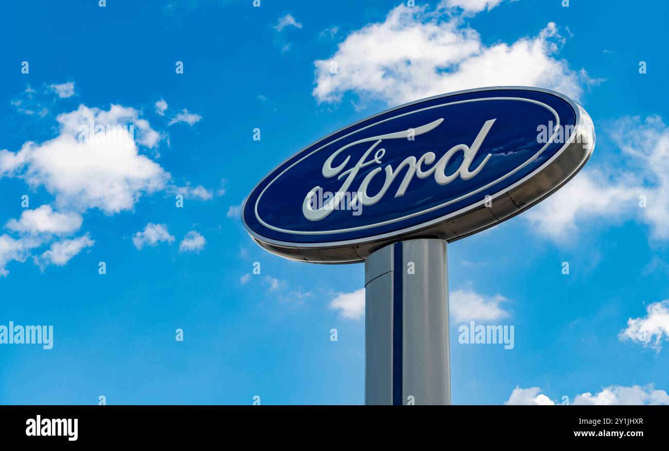 Chicago, USA - August 17, 2024: Ford logo sign against blue cloudy sky ...