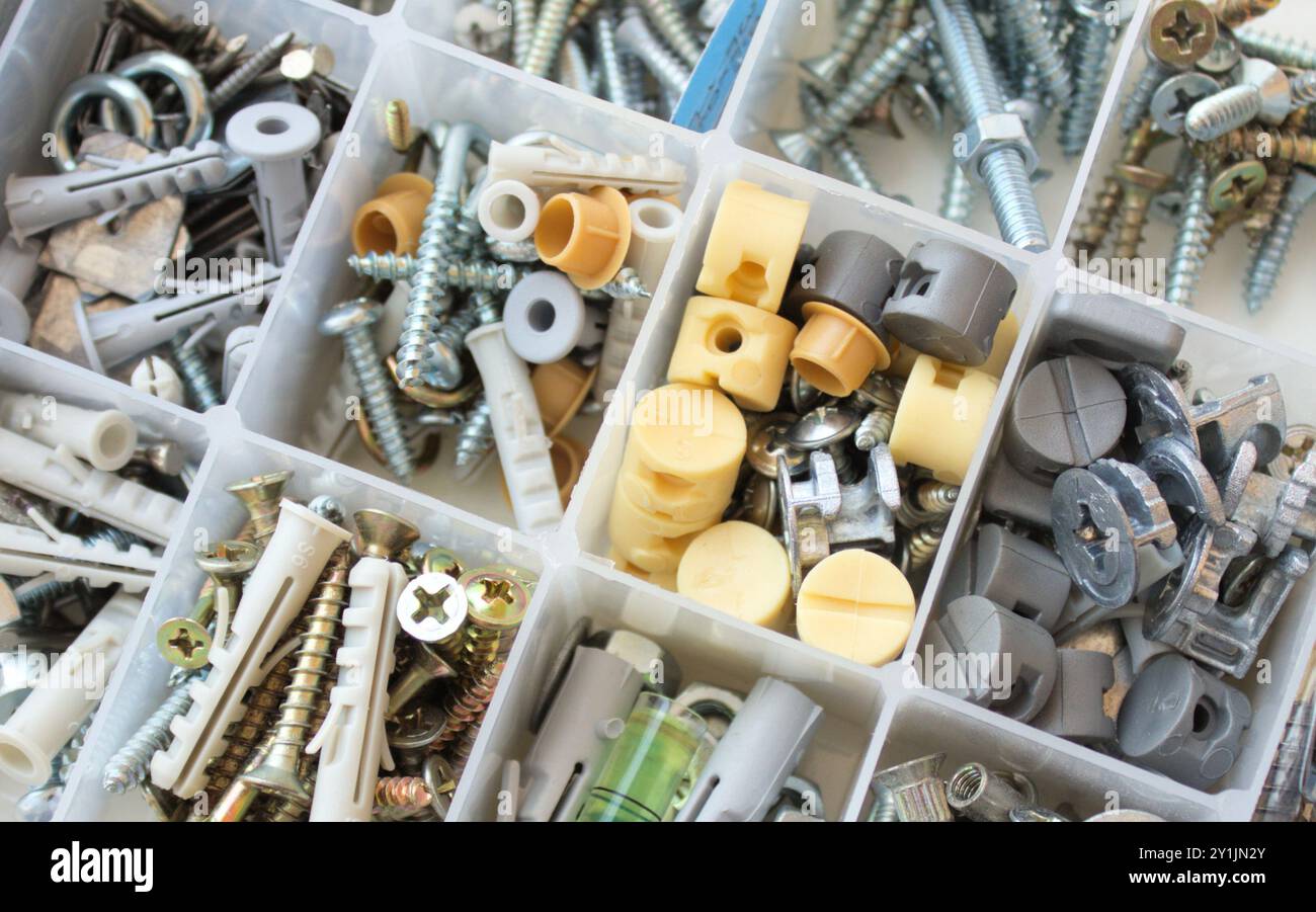 Screws, bolts, washers and ribbed anchors in a carpentry workshop ...