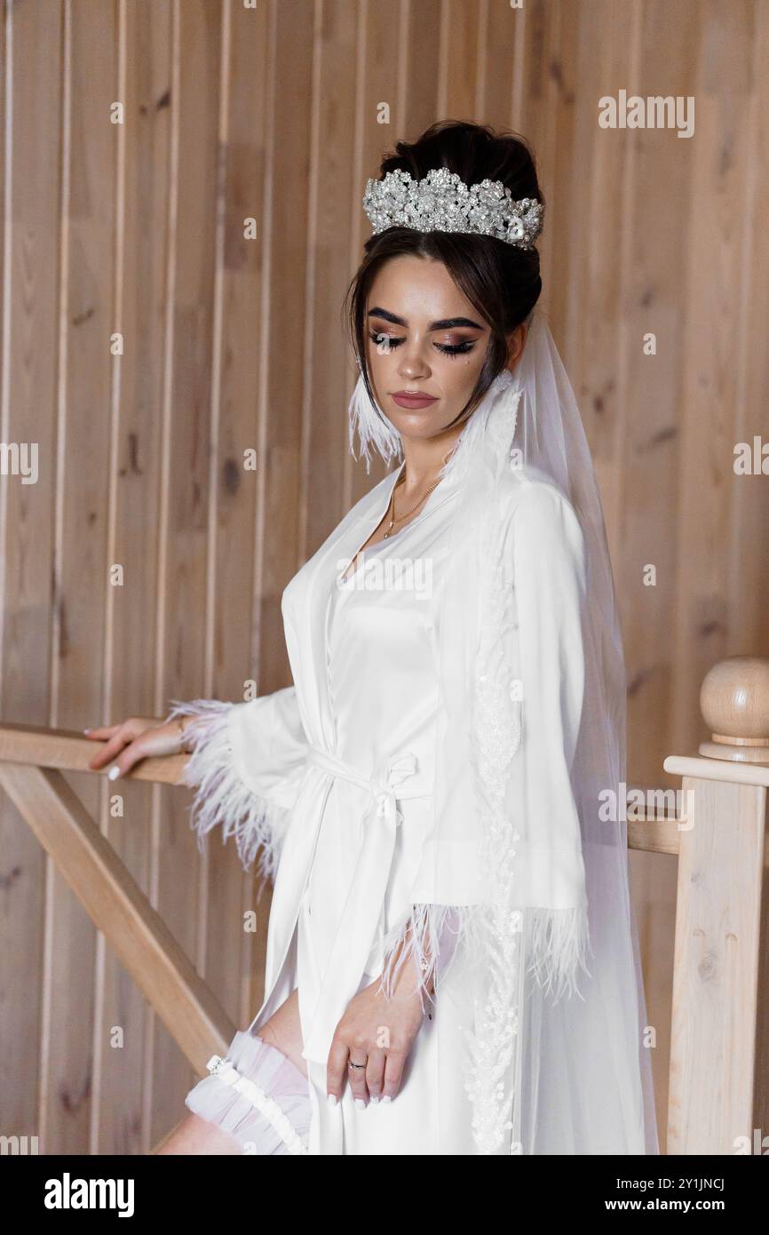 Elegant Bride in Luxurious Robe with Ornate Tiara and Veil by Rustic ...