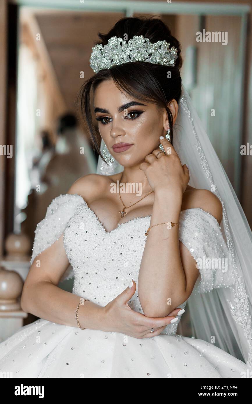 Elegant Bride in Sparkling White Gown with Ornate Crystal Tiara and ...