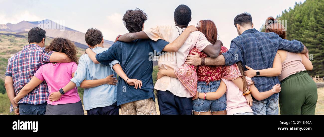 Panoramic rear view of diverse group of friends hugging. Multicultural ...