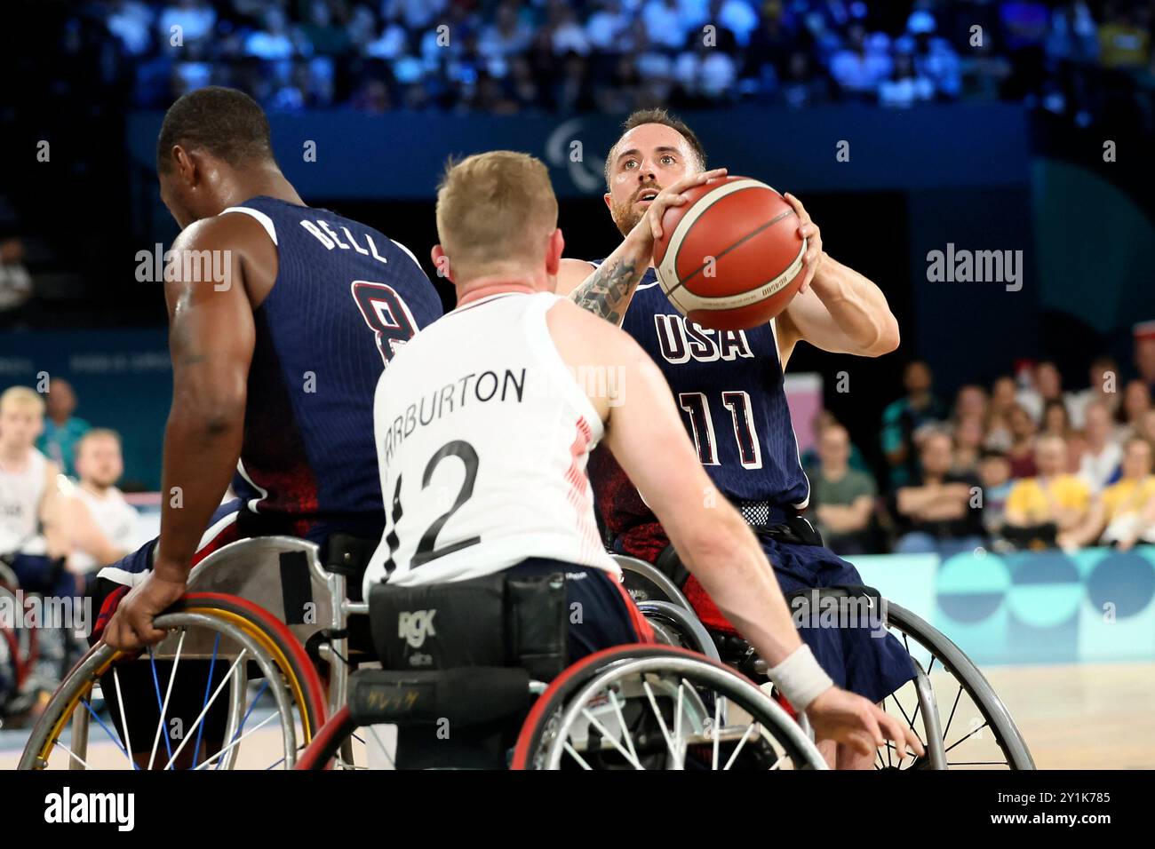 Steve Serio of the U.S. tries to score as Britain's Gregg Warburton ...