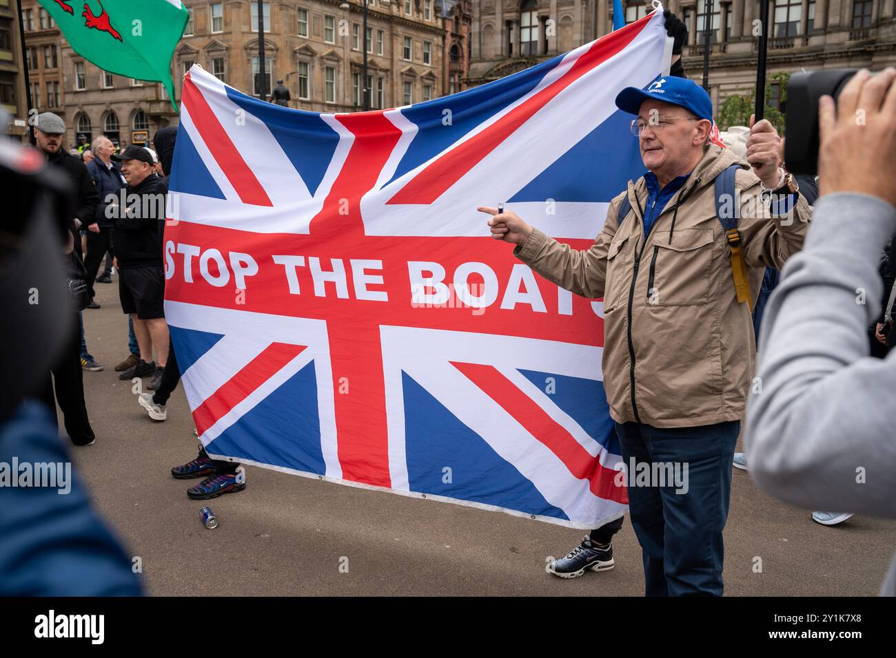 Protestors hold up a Union Flag with a "Stop the Boats" slogan Stock ...