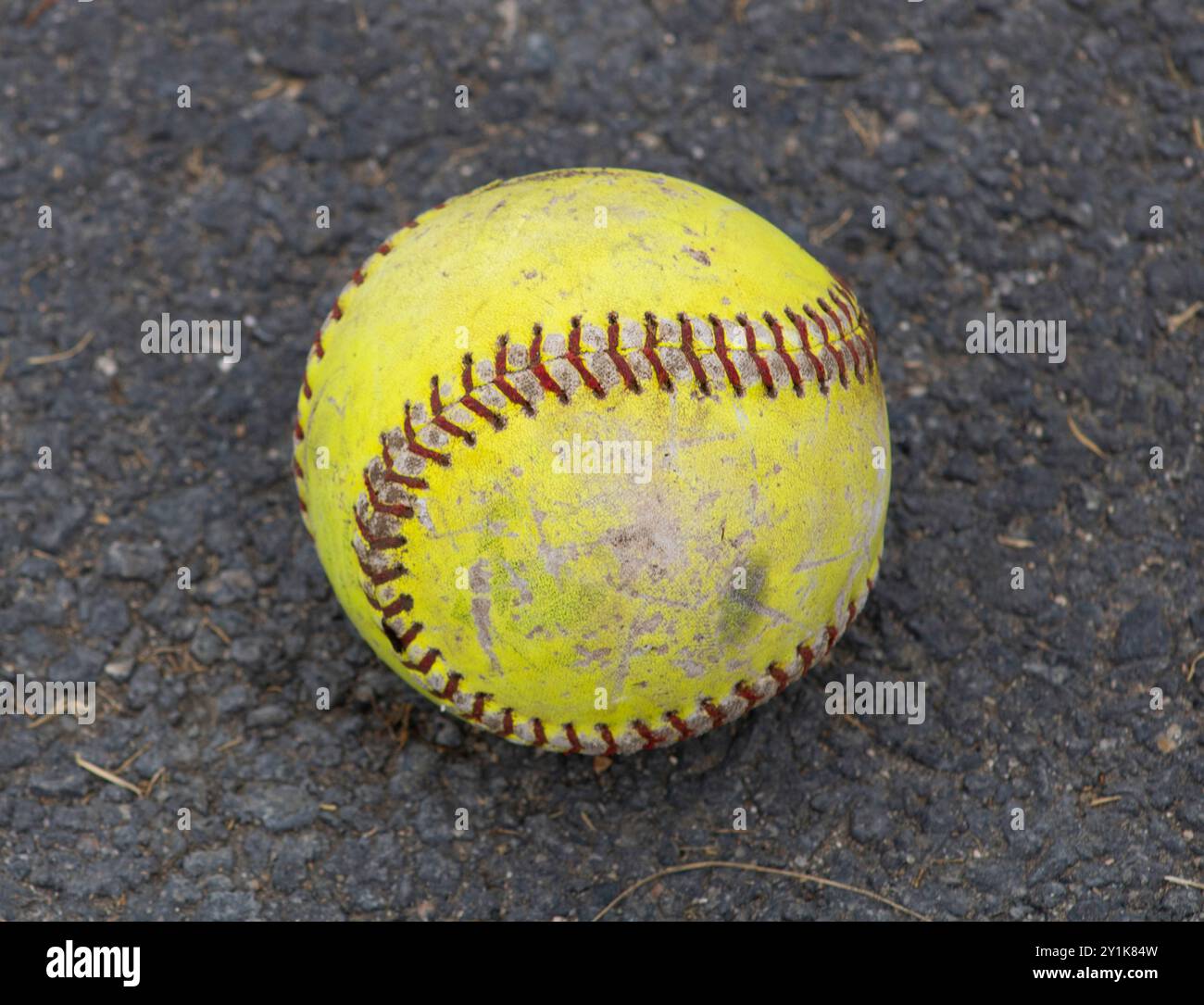 girls fastpitch yellow softball with red seams Stock Photo - Alamy