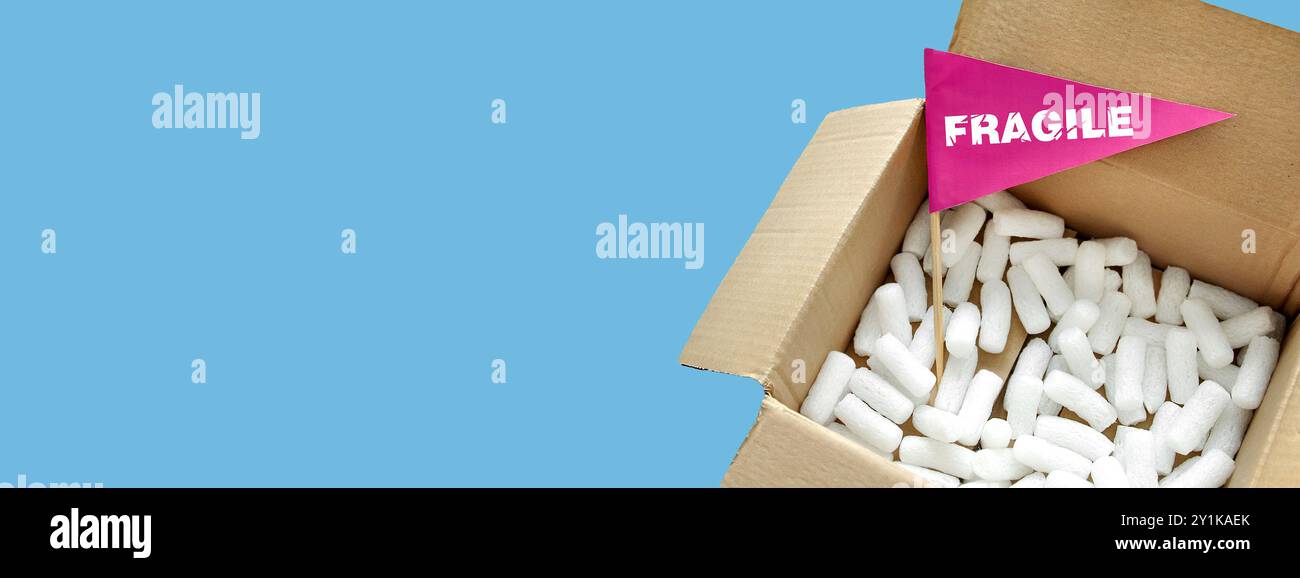 Fragile items packaging. Opened cardboard packaging box with white ...