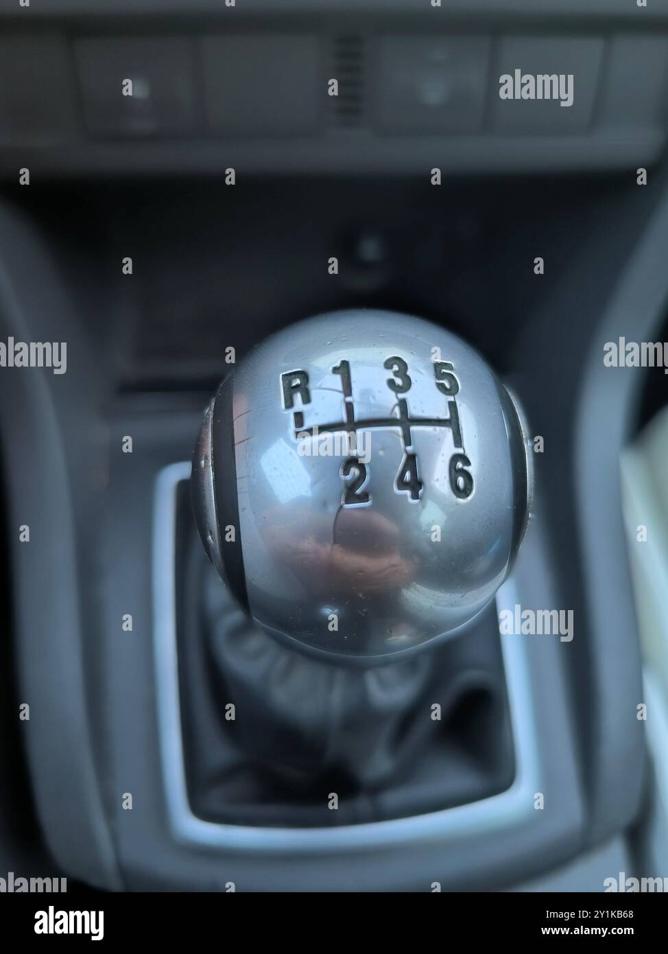 manual gear lever of a silver utility car where the numbers of each ...
