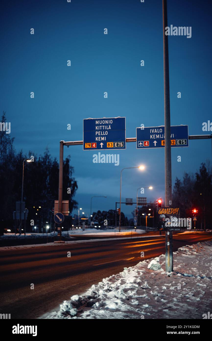 Road signs in the snow at twilight in Rovaniemi, Lapland in winter ...
