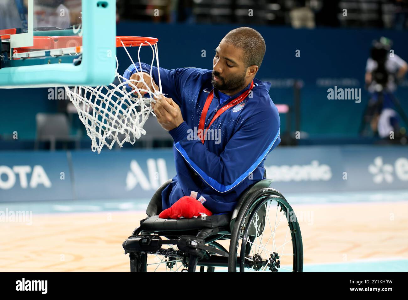 Trevon Jenifer of the U.S. cuts the net from the basket after winning ...