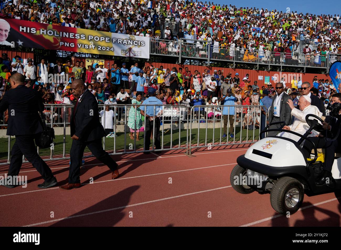 Pope Francis arrives on a golf cart at the Sir John Guise Stadium in ...