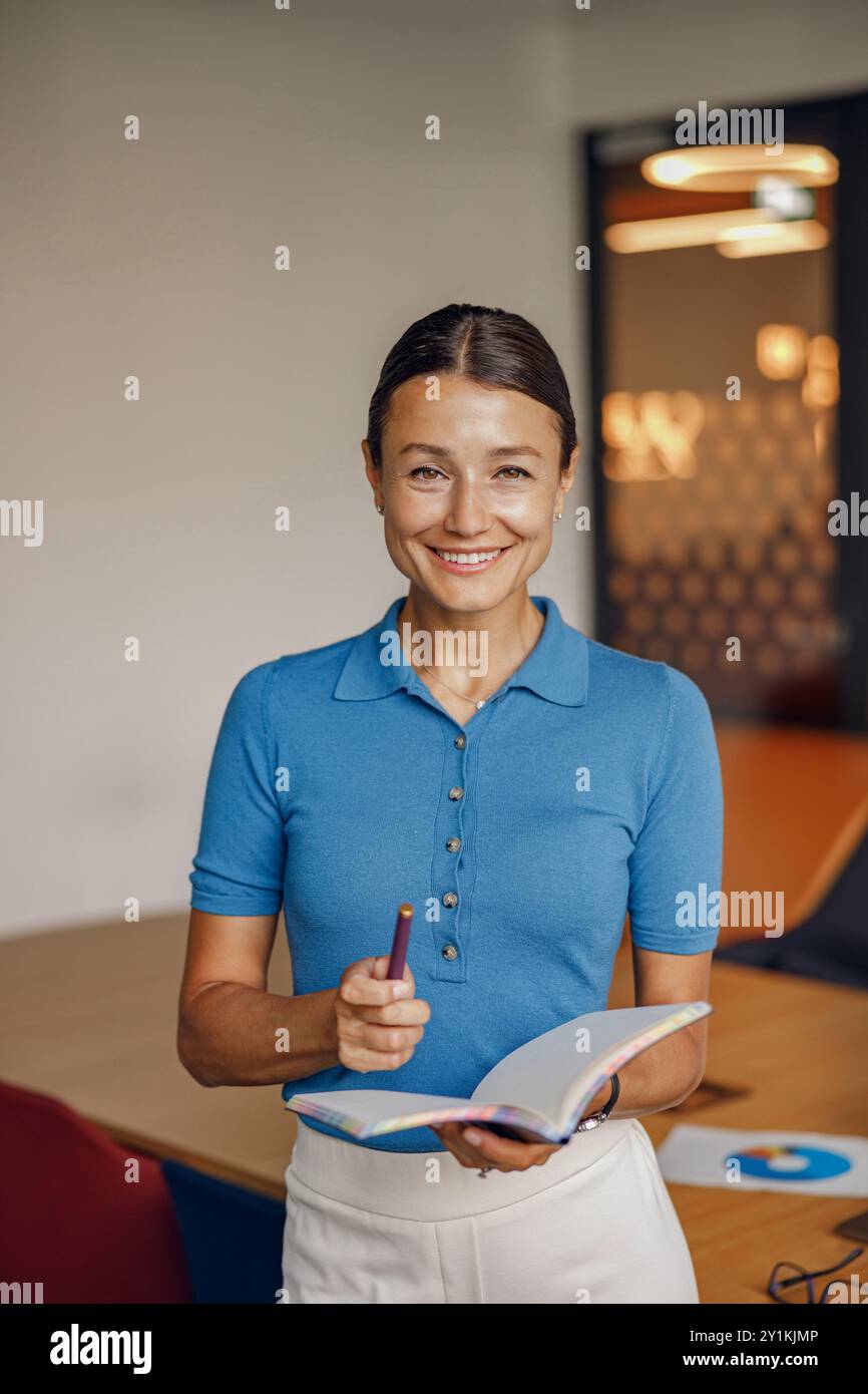 A Smiling Professional Woman Working in a Bright and Modern Workspace ...