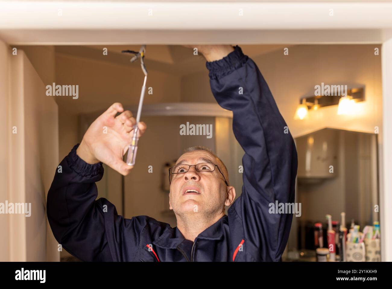 An electrician checking the phase of the electric wire, using an ...