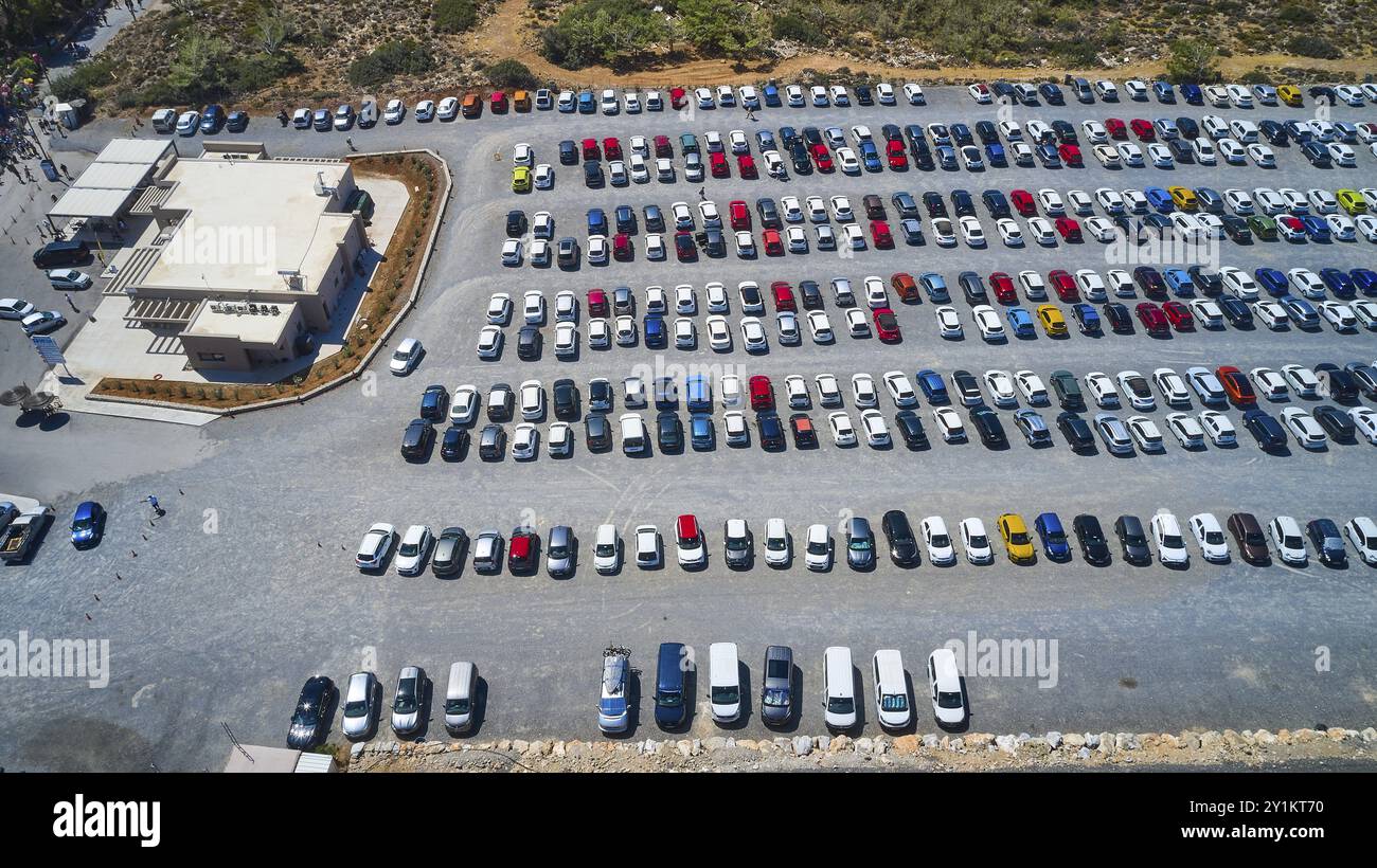 Overtourism, aerial view of a full car park with many different cars in ...