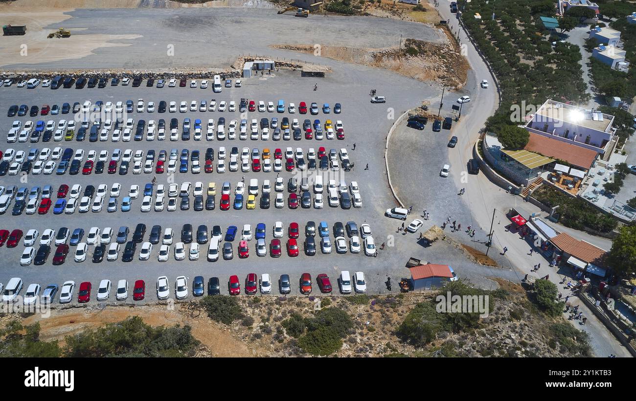 Overtourism, aerial view of a large car park with many parked cars ...
