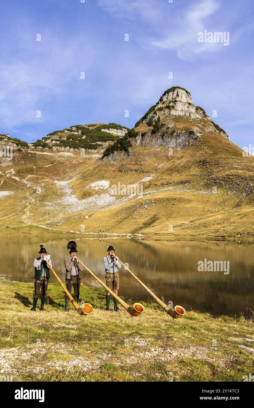 Three men play the alphorn at Lake Augstsee on Mount Loser. The ...