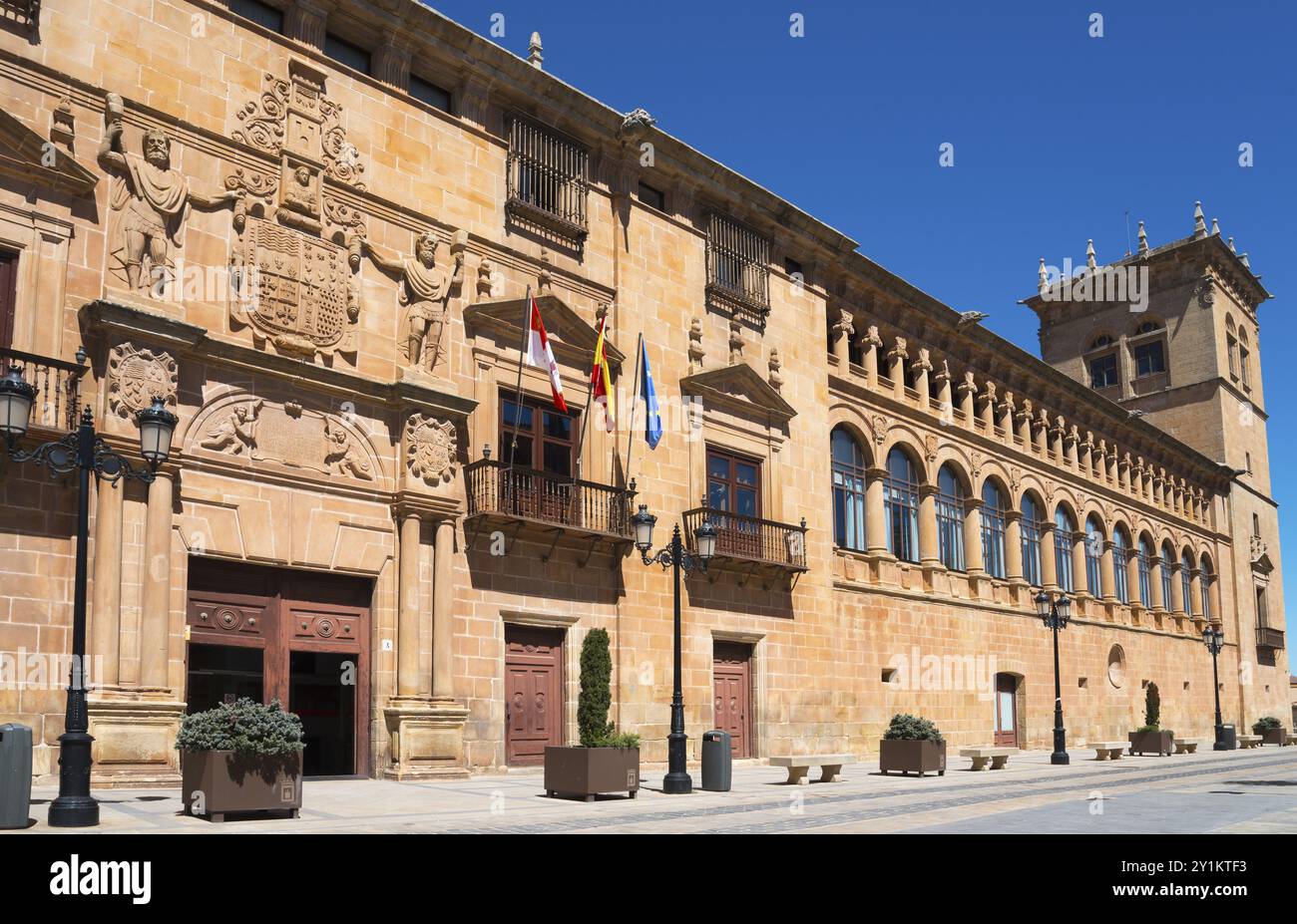 Historic facade of a building with flags and arches, bright sunshine ...