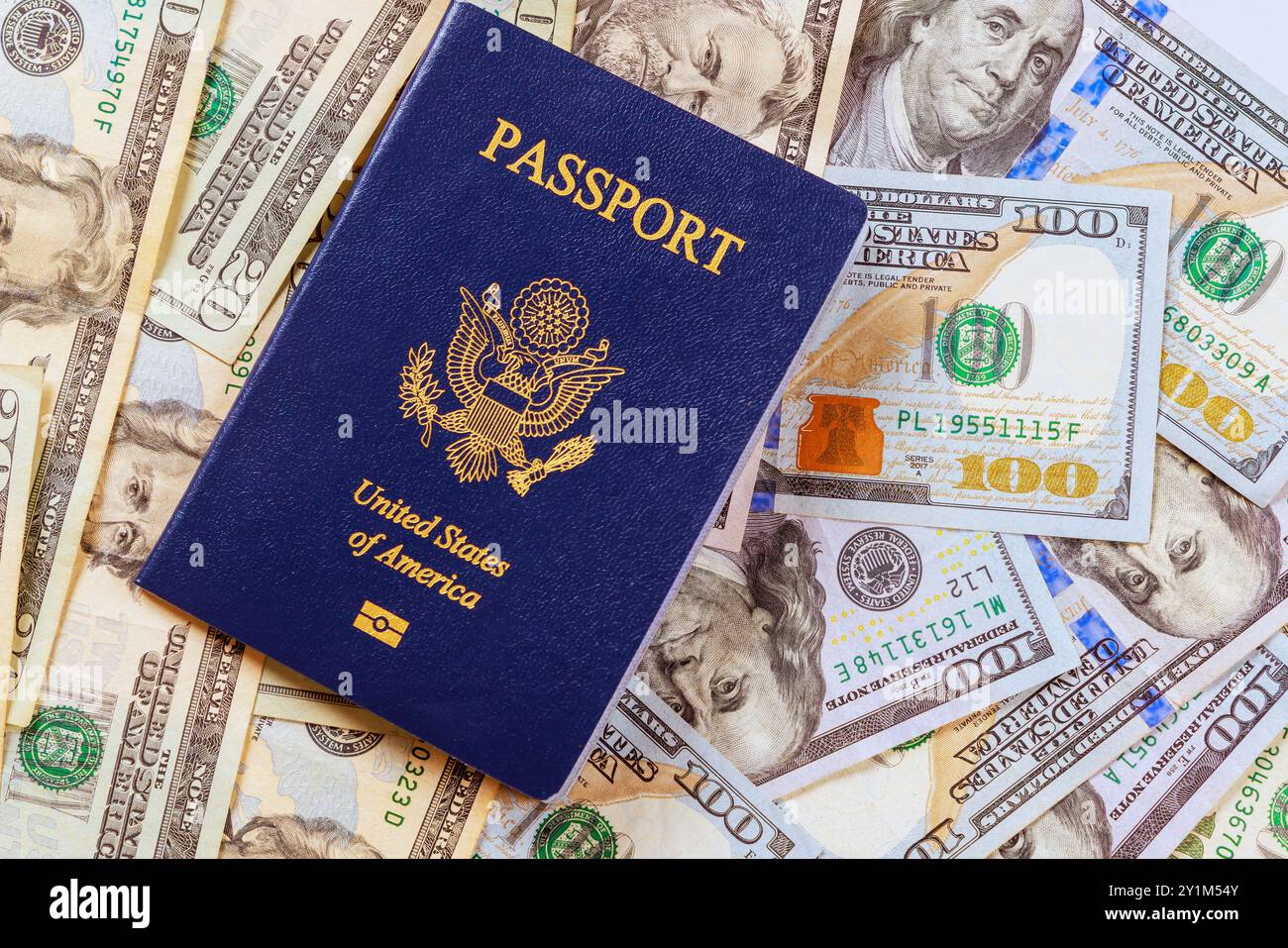 An American passport on top American dollar cash banknote of different ...
