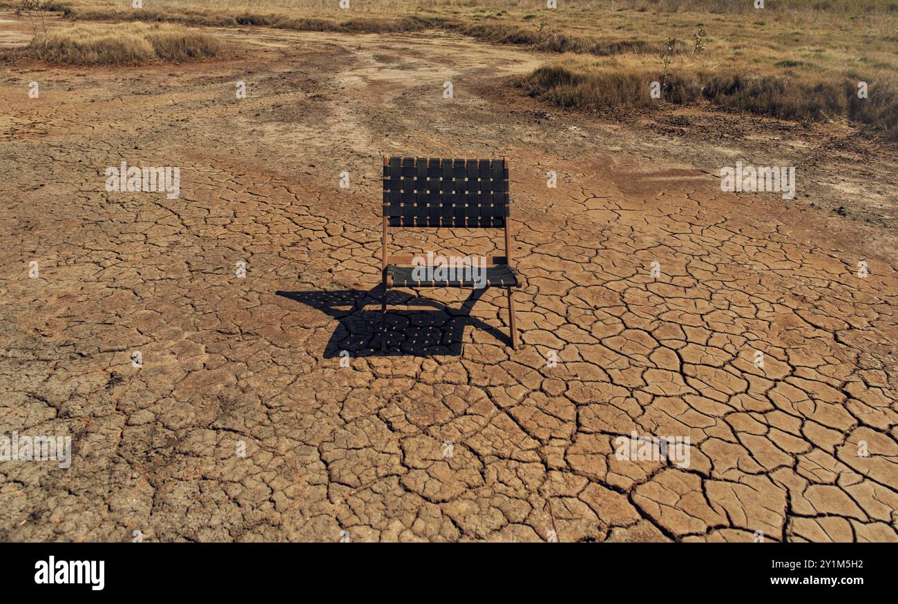 Chair on dry mud Stock Photo - Alamy
