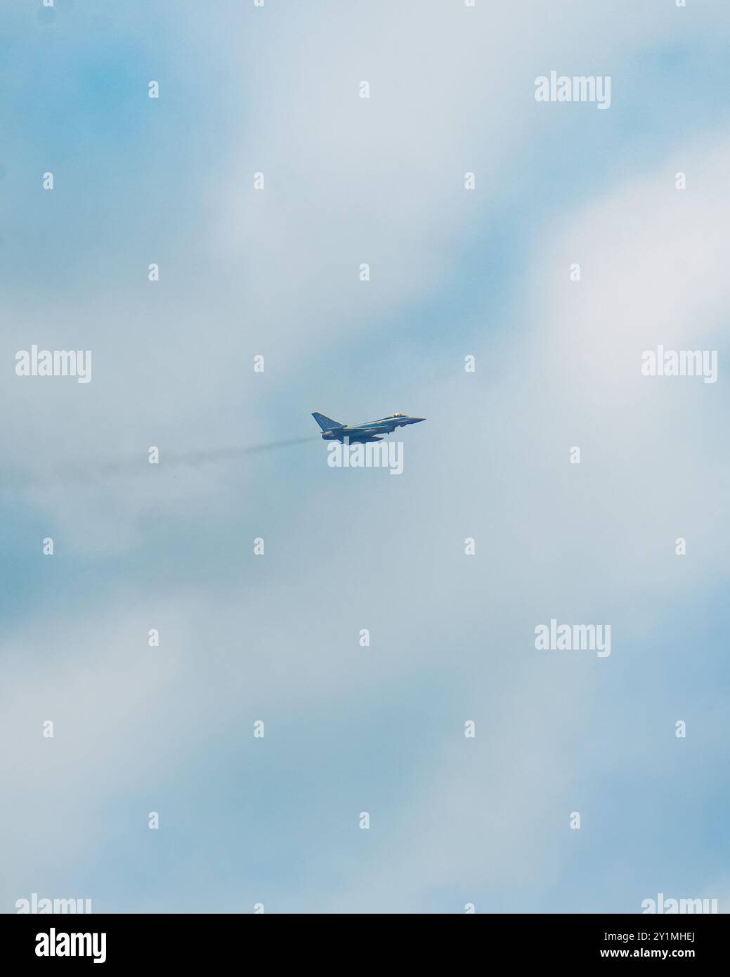 Aerial view of a fighter jet flying high above the beautiful clouds ...