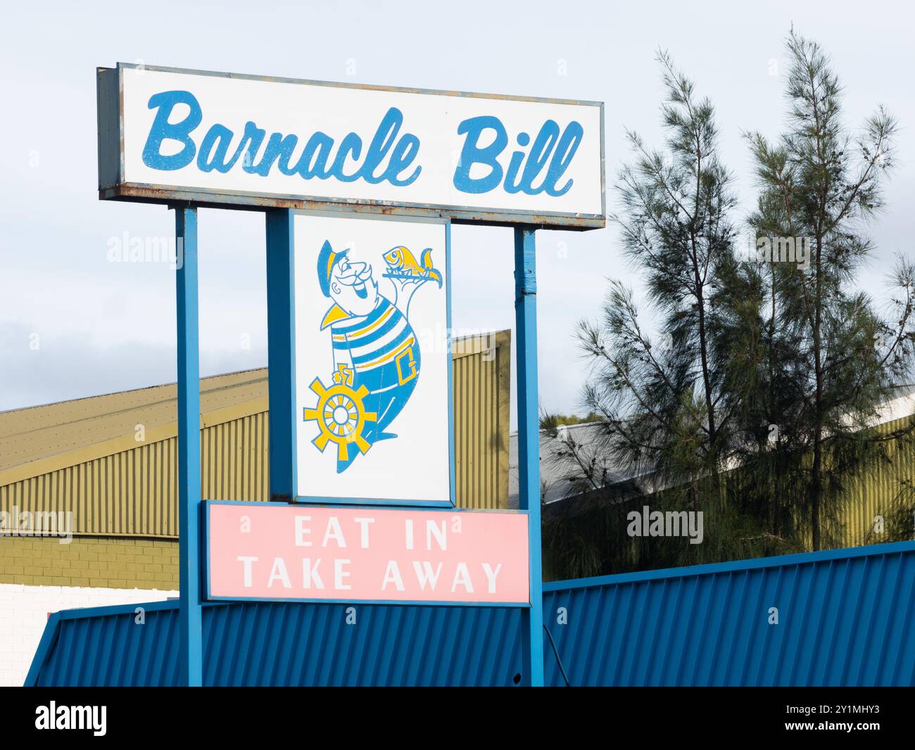 Barnacle Bill seafood restaurant signage and artwork with buildings and ...