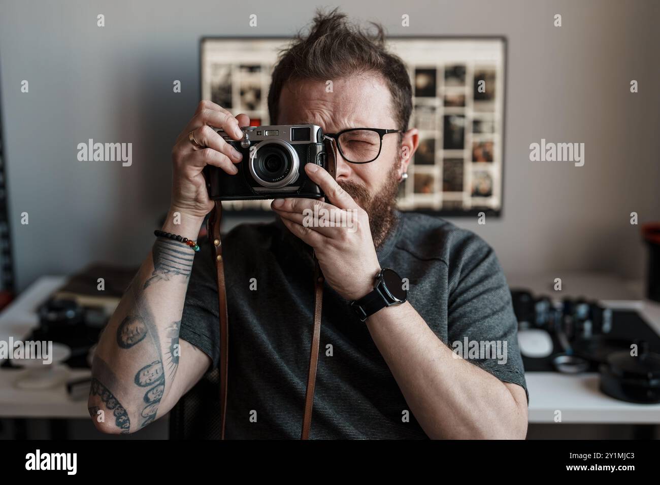 Photographer with camera focusing on his work Stock Photo - Alamy
