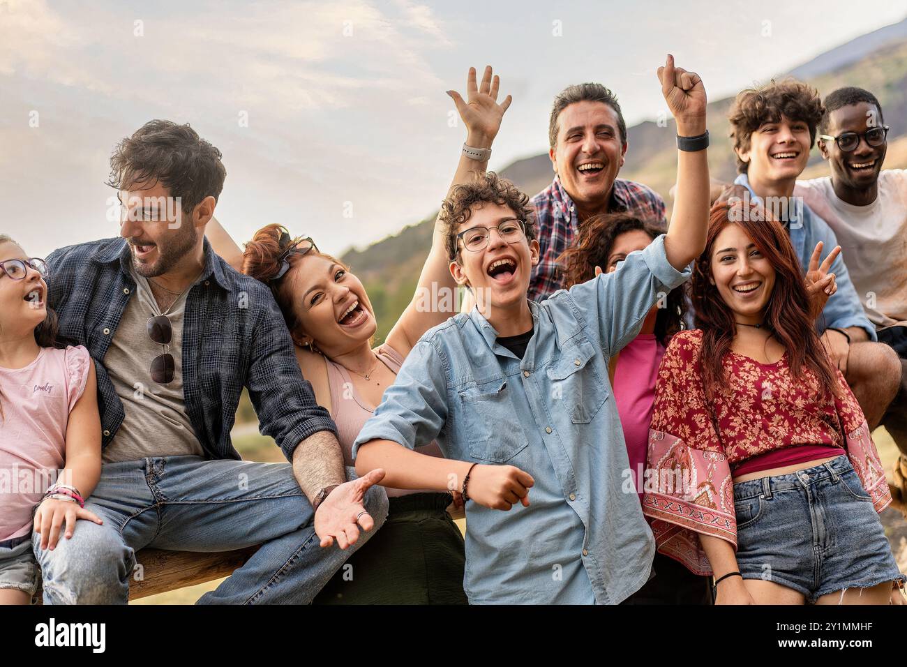 Ecstatic diverse group of friends and family celebrating outdoors ...