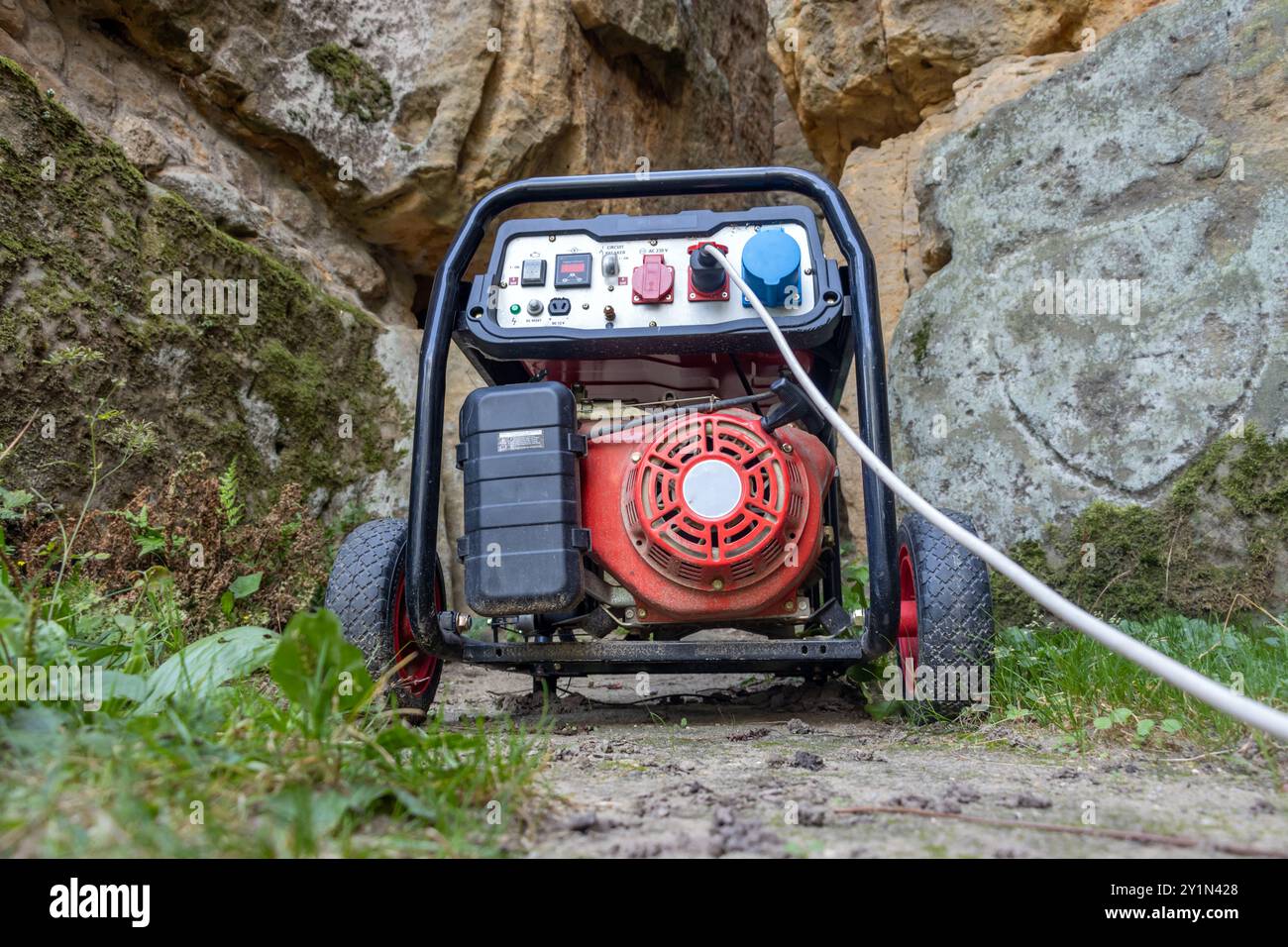 Portable three-phase electricity generator by the rock Stock Photo - Alamy
