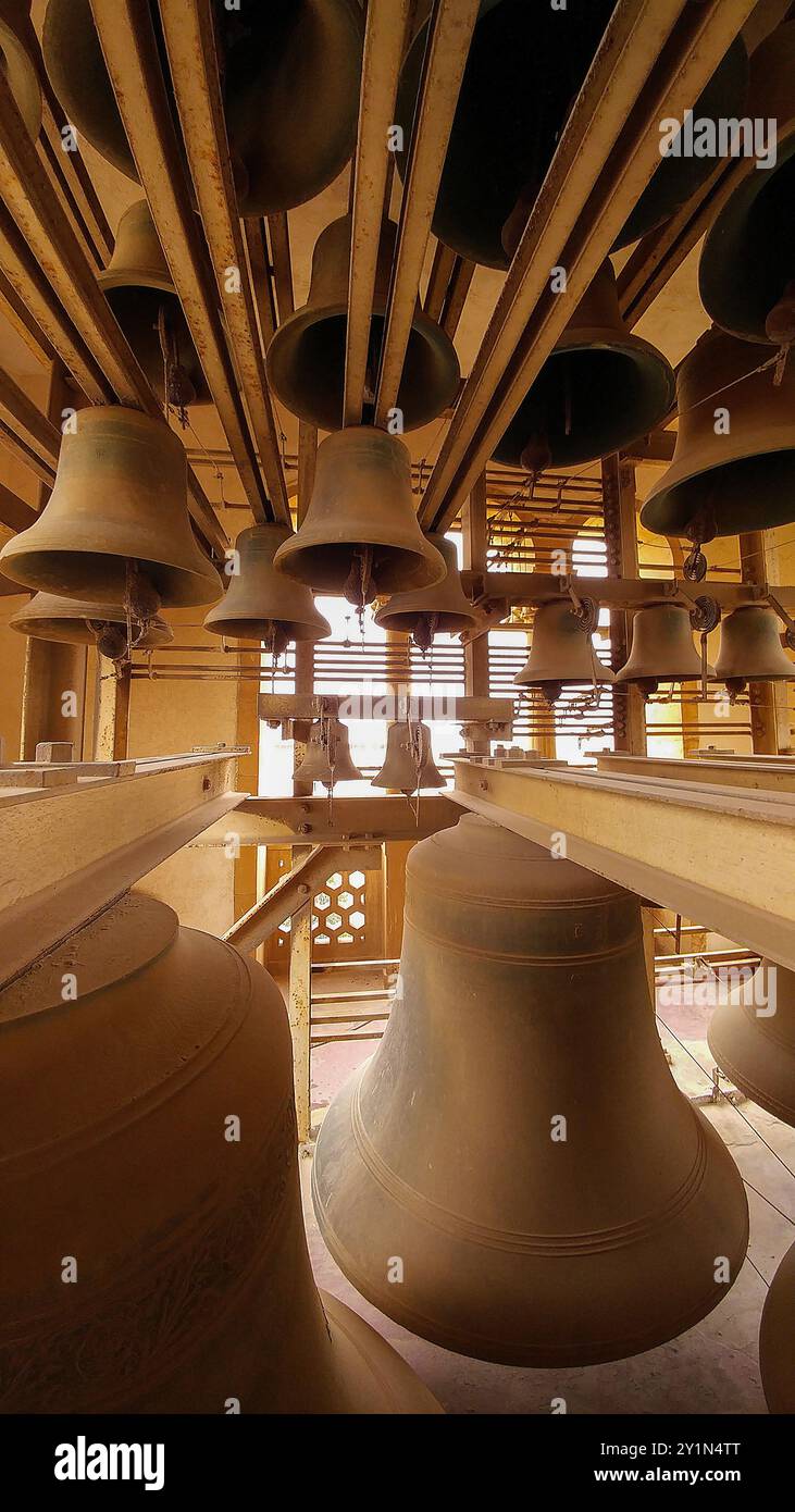 Multiple large Iron bells and steel clappers hanging from the rafters ...