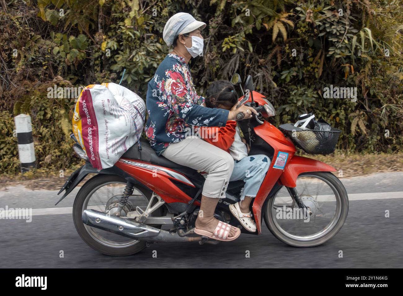BETONG, THAILAND, MAR 02 2024, An elderly woman is carrying a child and ...