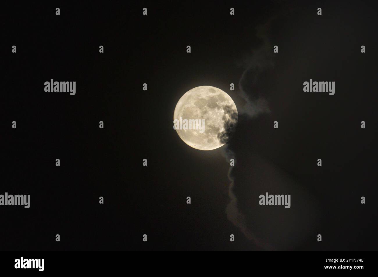 Dark clouds passing past the supermoon of 19 August 2024. Photographed in the western part of ...