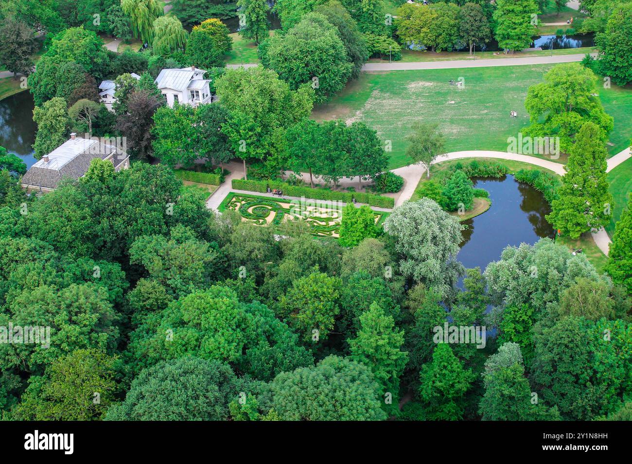Aerial view of a lush green park featuring manicured gardens, winding ...