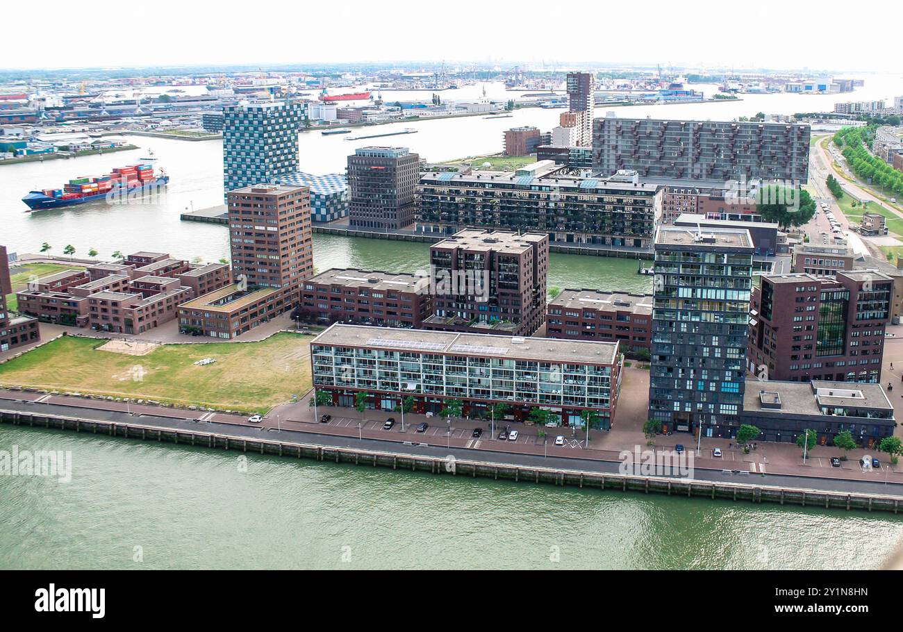 Aerial view of modern urban architecture along a waterfront, featuring ...