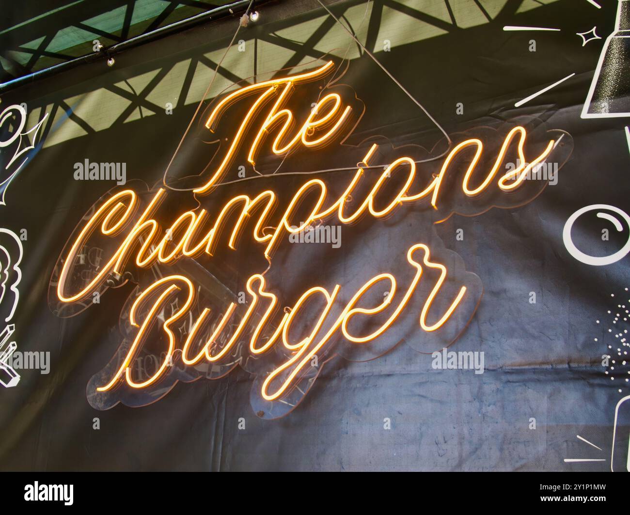 Neon sign inside a photo booth at The Champions Burger food event ...