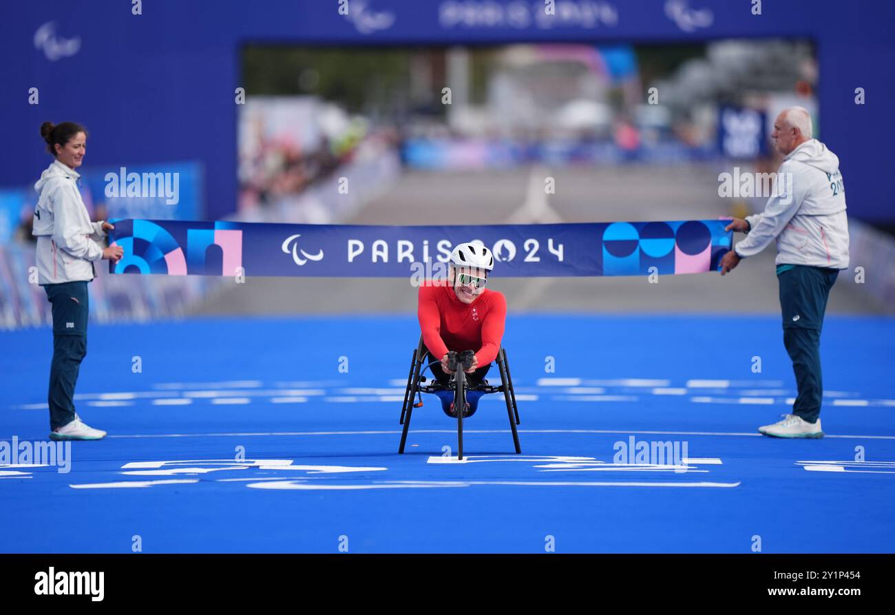 Switzerland's Catherine Debrunner crosses the finish line to win gold ...