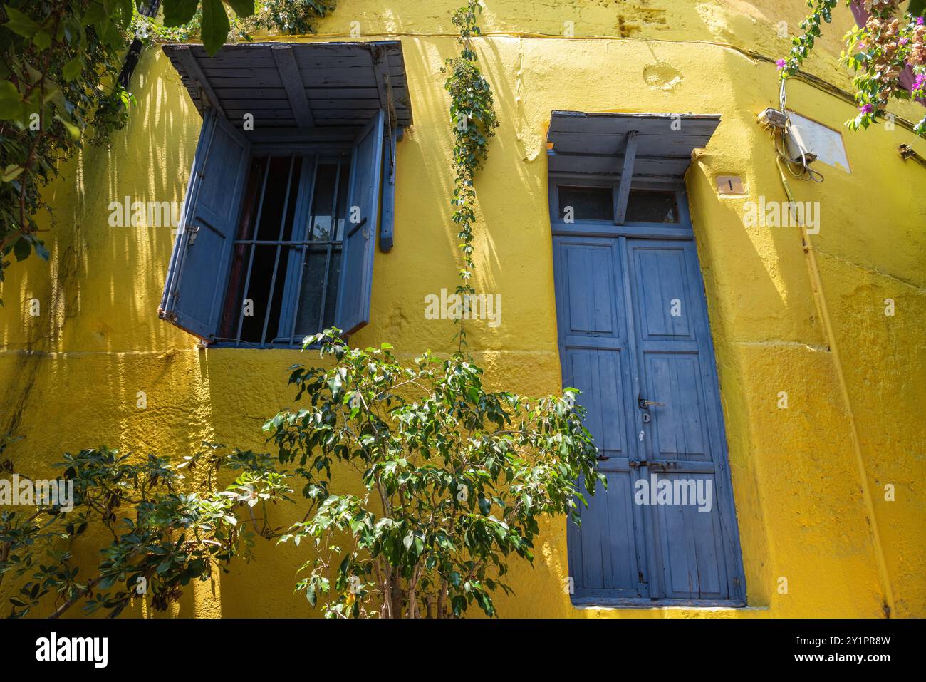 Yellow-coloured historic building with blue doors in Rhodes Town ...